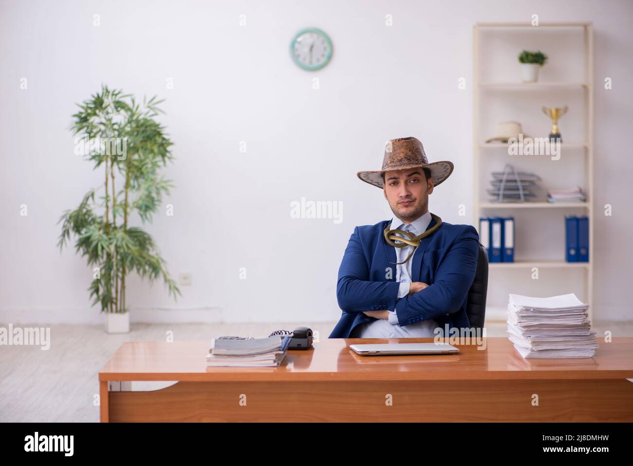Young cowboy employee working at workplace Stock Photo - Alamy