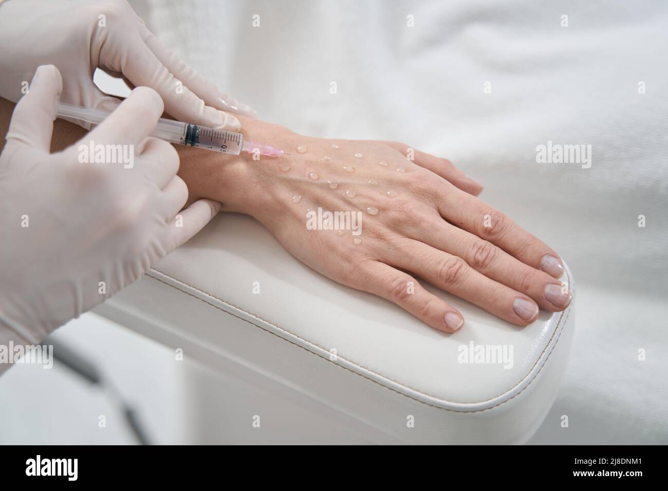 Woman receiving hand rejuvenation injection in beauty salon Stock Photo ...