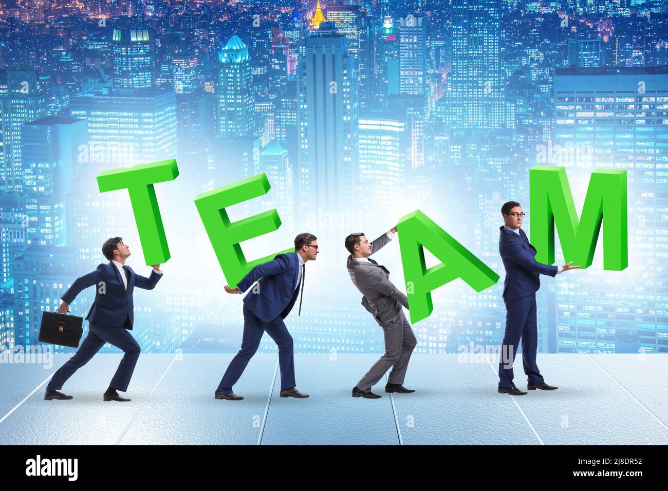 Teamwork concept with the people carrying team letters Stock Photo - Alamy