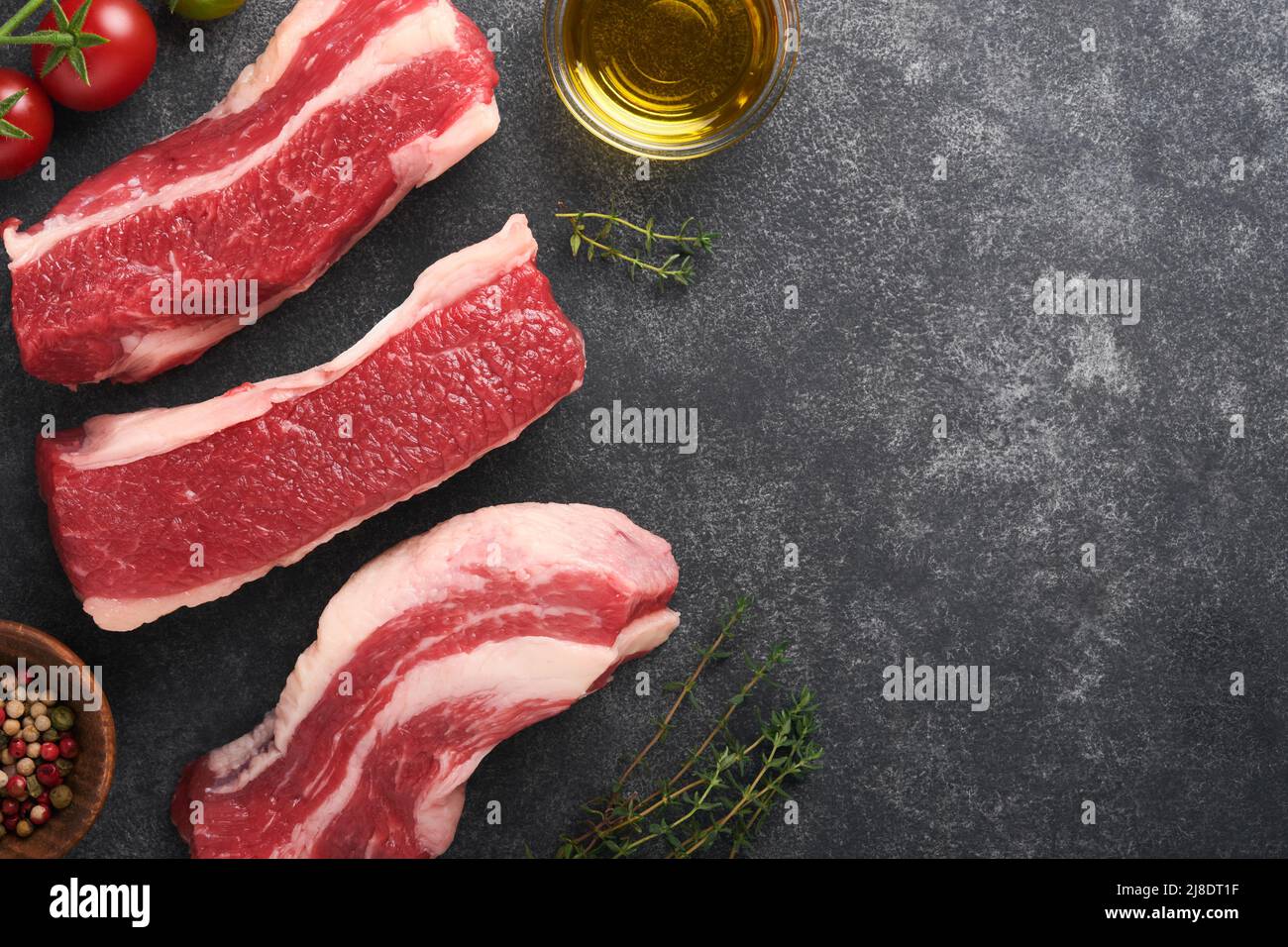 Steak beef. Raw steak New York with rosemary and spices on a piece of ...