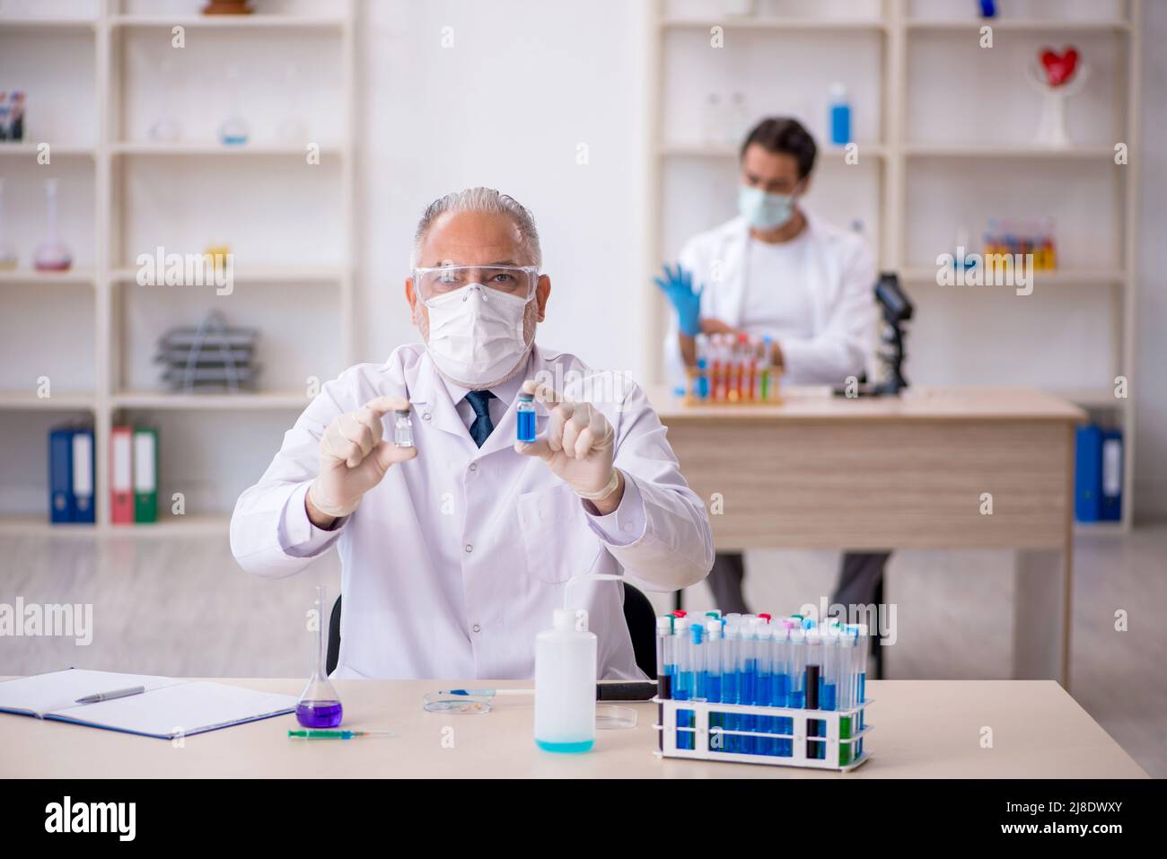 Two chemist working at the lab Stock Photo - Alamy