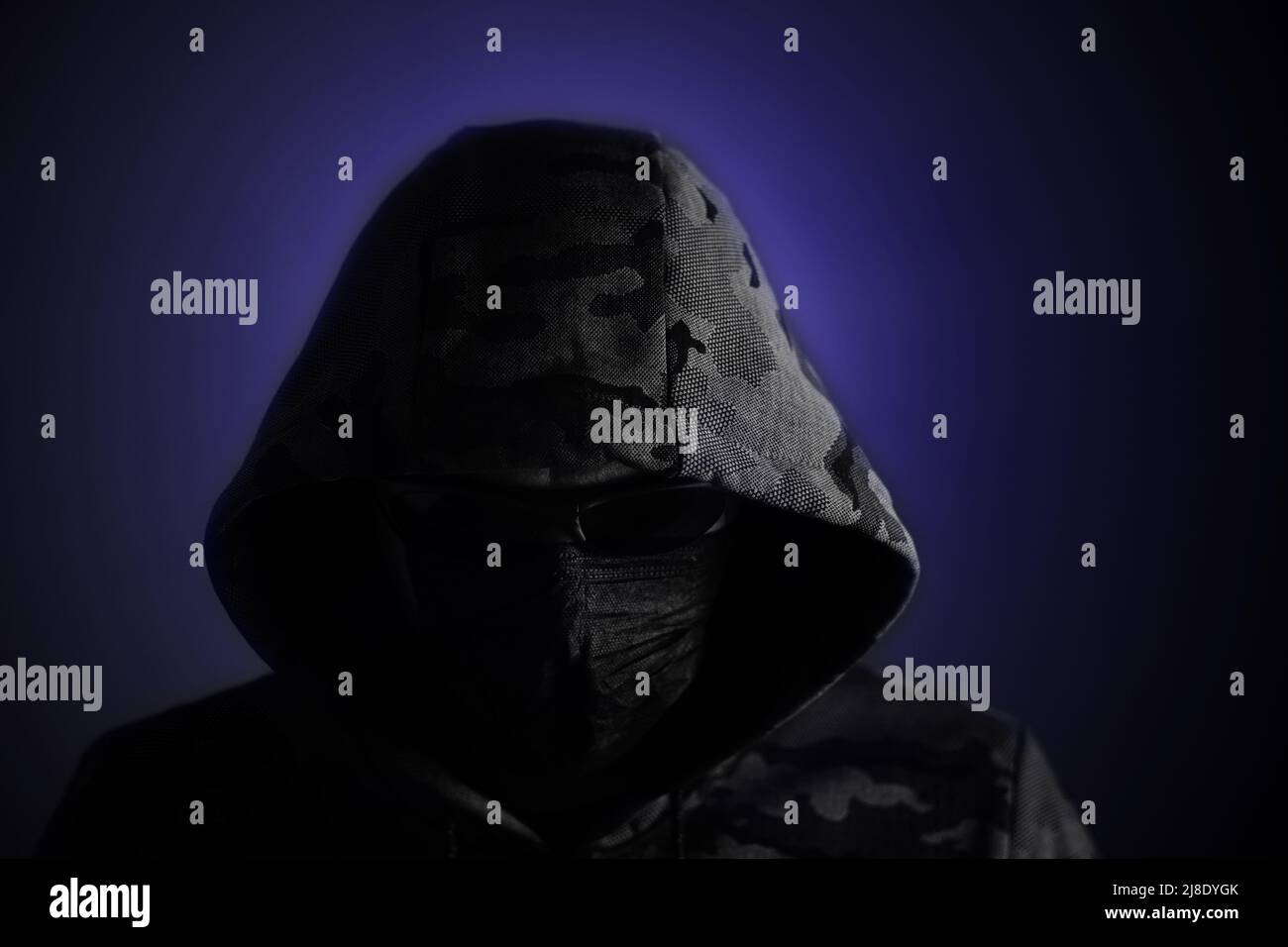 Stylish man in dark hoodie, black glasses and mask dark background in ...