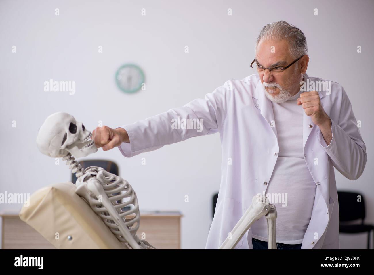 Old doctor with skeleton at the hospital Stock Photo - Alamy