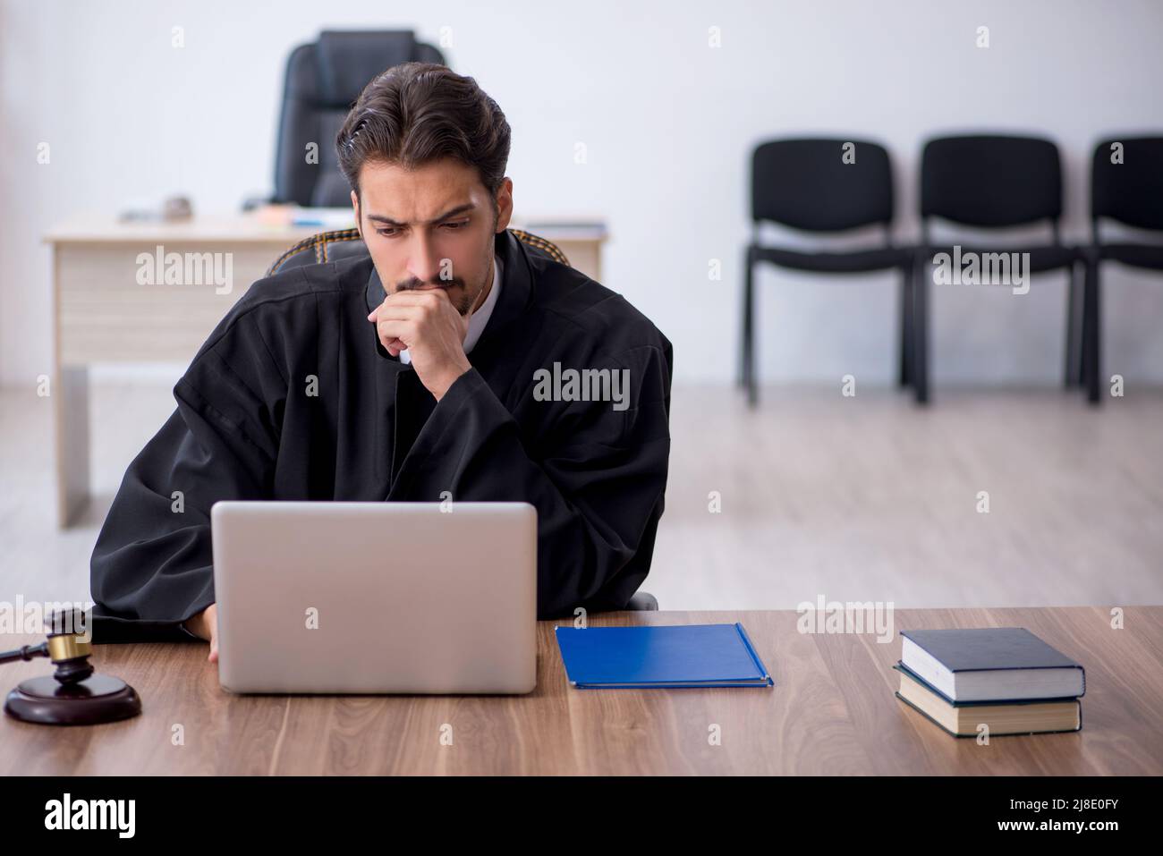 Young judge working in the courthouse Stock Photo - Alamy