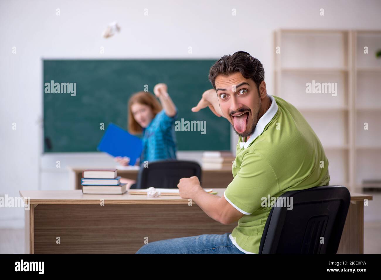 Two students having fun during the lesson Stock Photo - Alamy