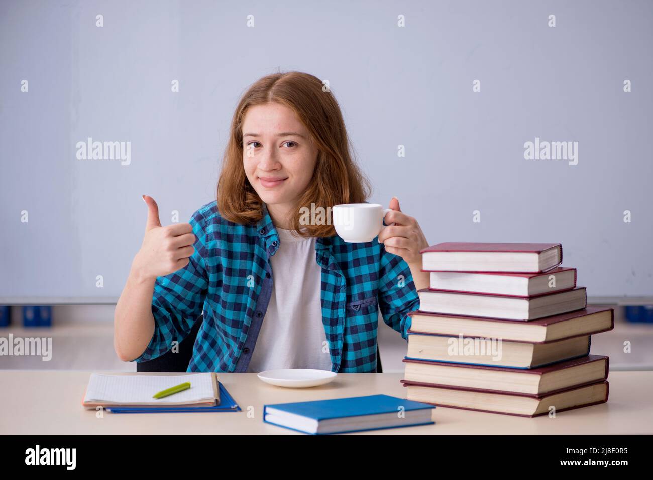 Young girl student drinking coffee during break Stock Photo - Alamy