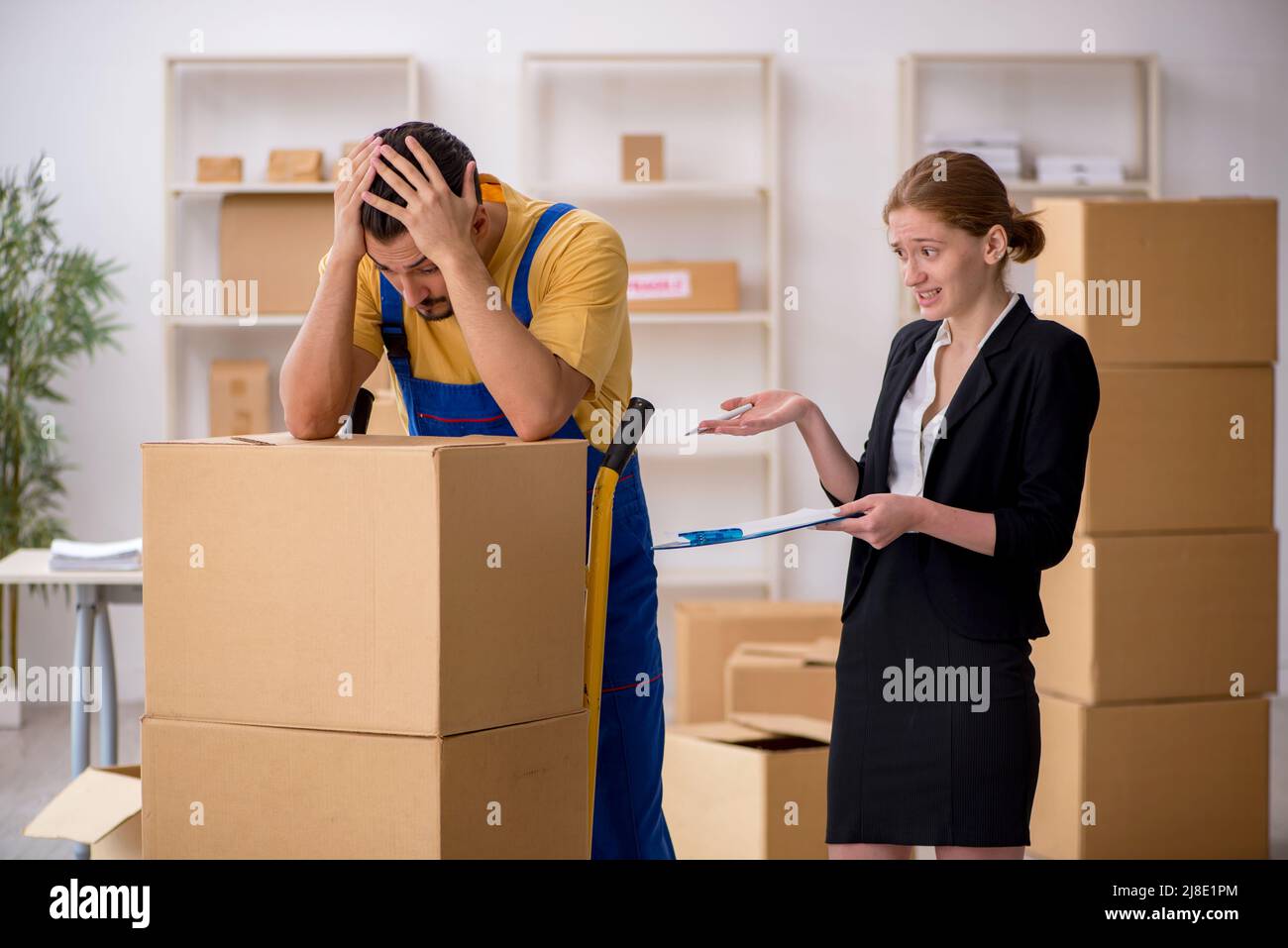 Female boss and male contractor doing home relocation Stock Photo - Alamy
