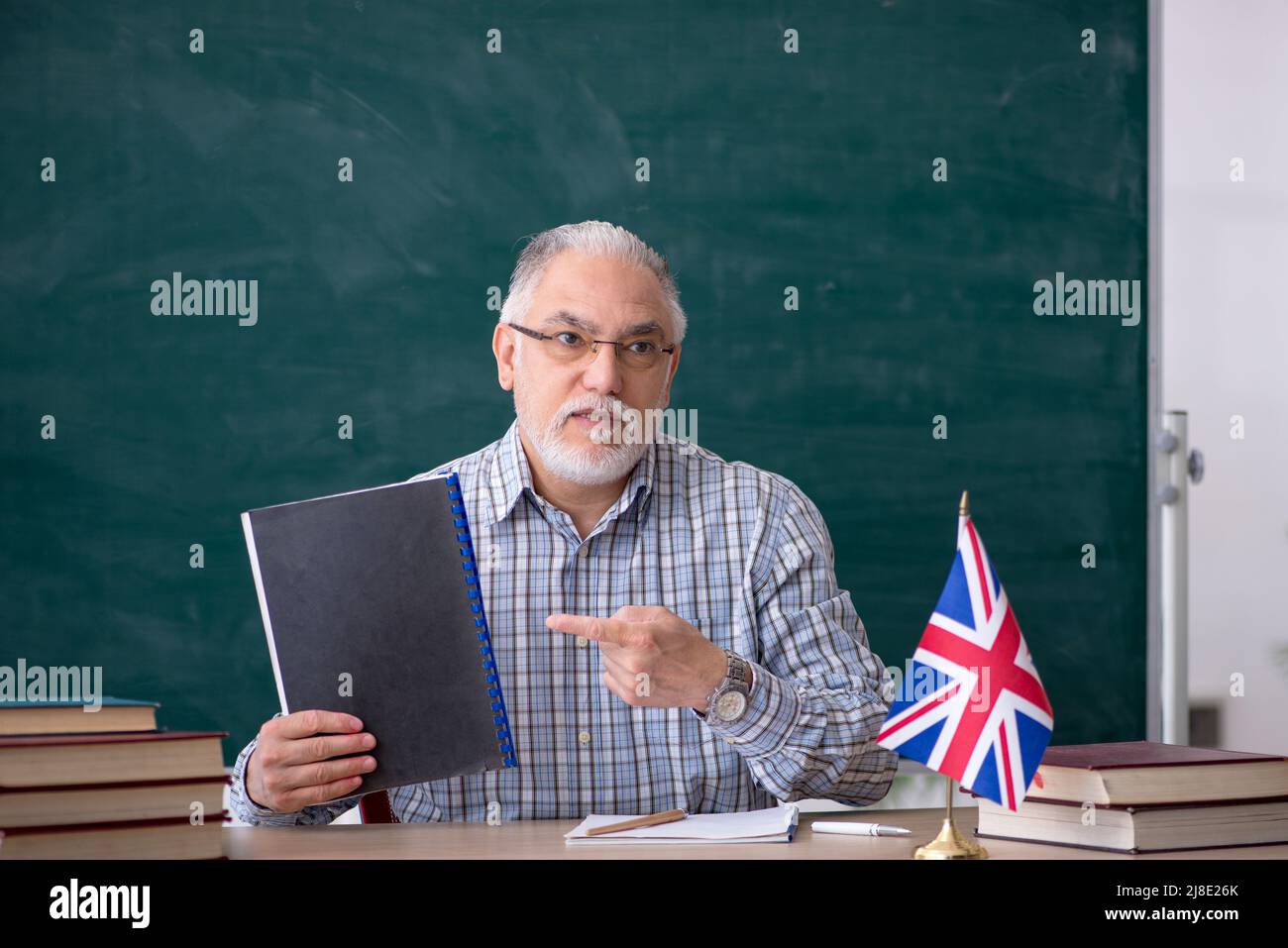 Aged english language teacher in the classroom Stock Photo - Alamy