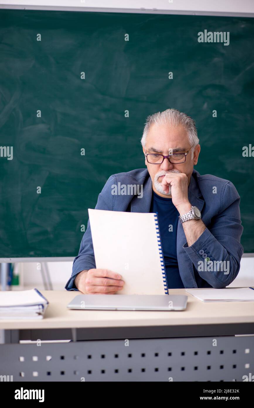 Old teacher in the classroom Stock Photo - Alamy