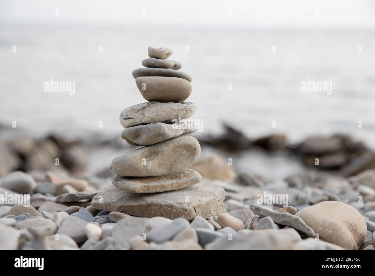 Pyramid of stones on the beach at sunset, beautiful seascape, rest and ...