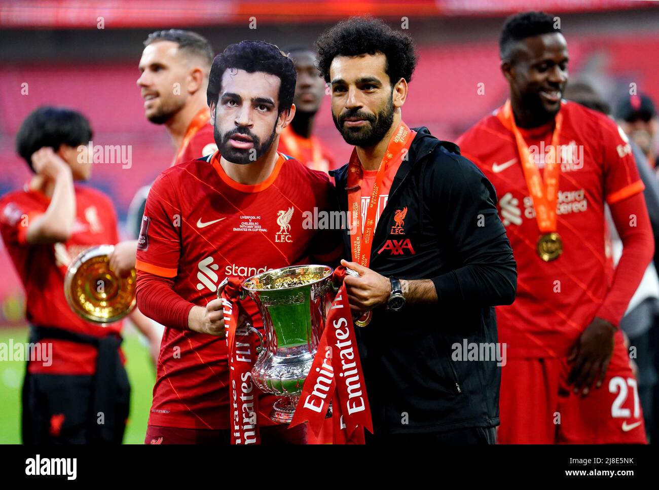 Liverpool's Harvey Elliott (left) wears a Mohamed Salah mask as he ...