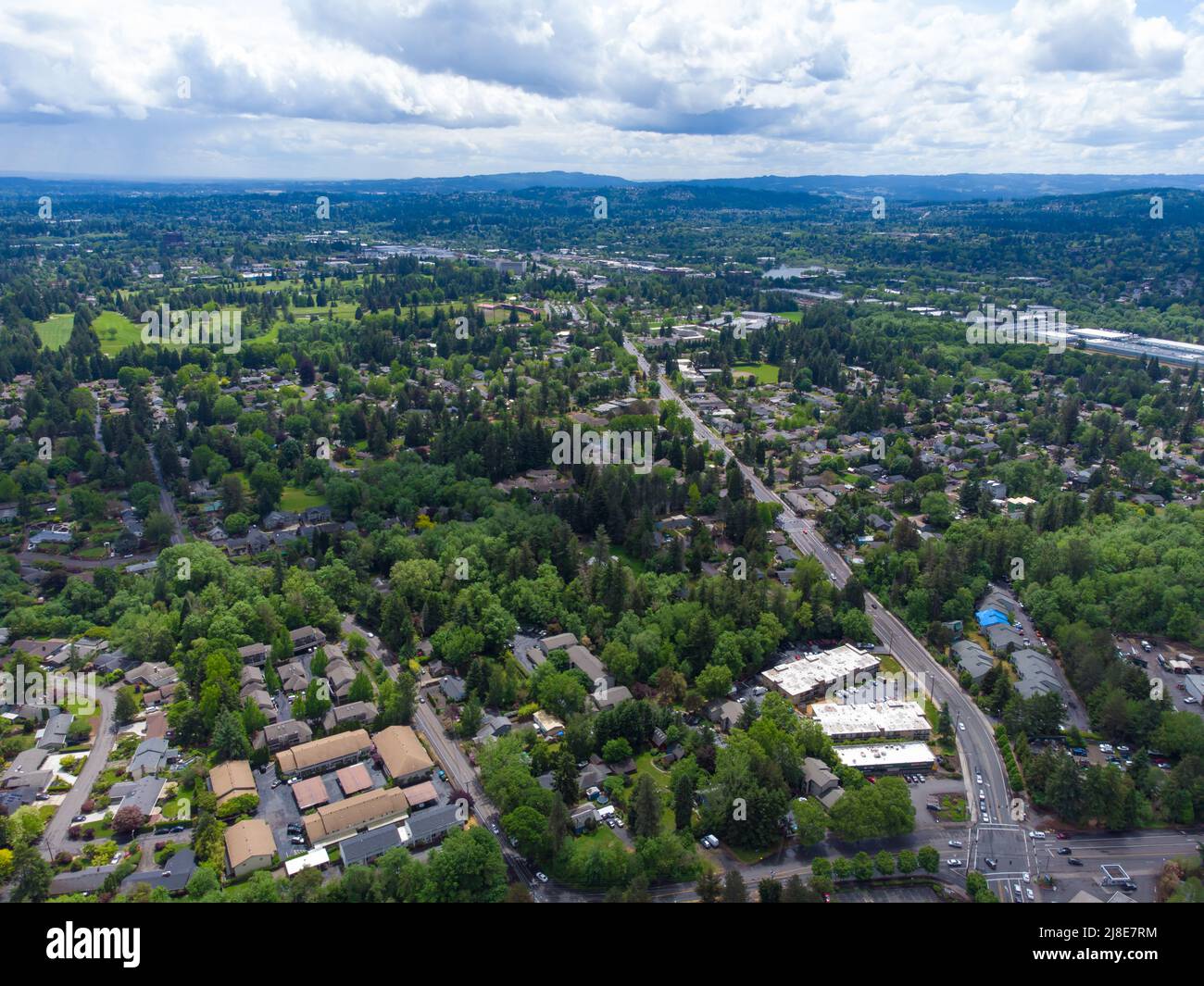 Aerial view of a small picturesque town. Lots of greenery, mountains ...