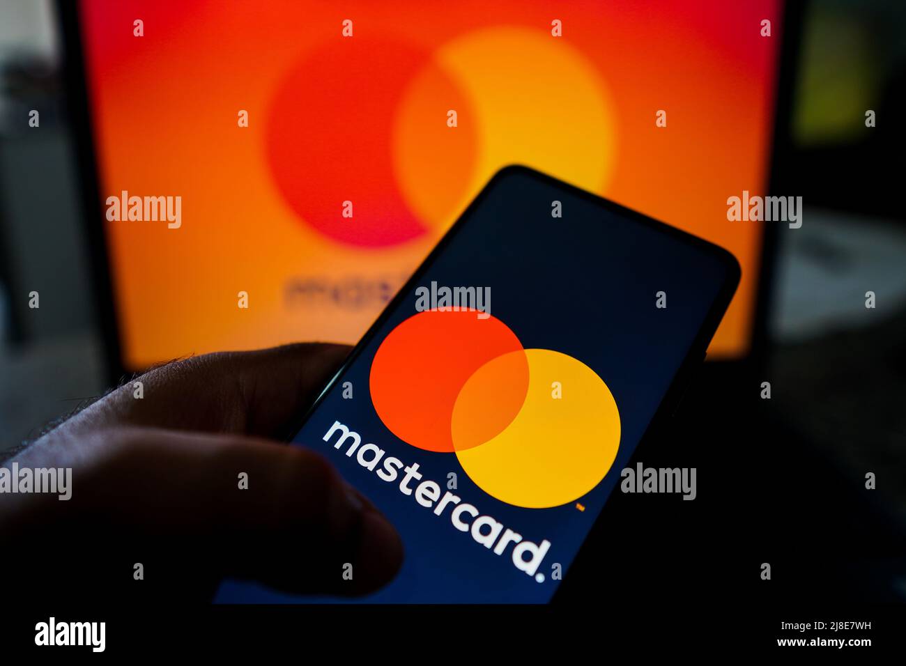 In this photo illustration the Mastercard logo seen displayed on a ...