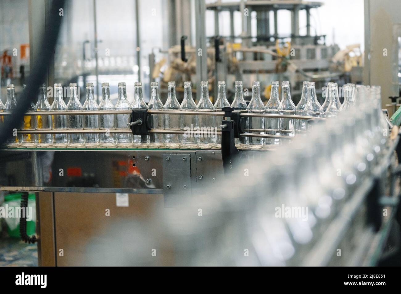 Production line transports empty glass bottles for alcohol Stock Photo ...