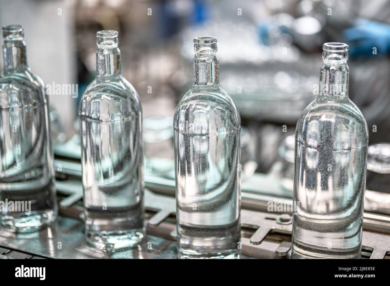 Bottles of luxury vodka on automated production line Stock Photo - Alamy