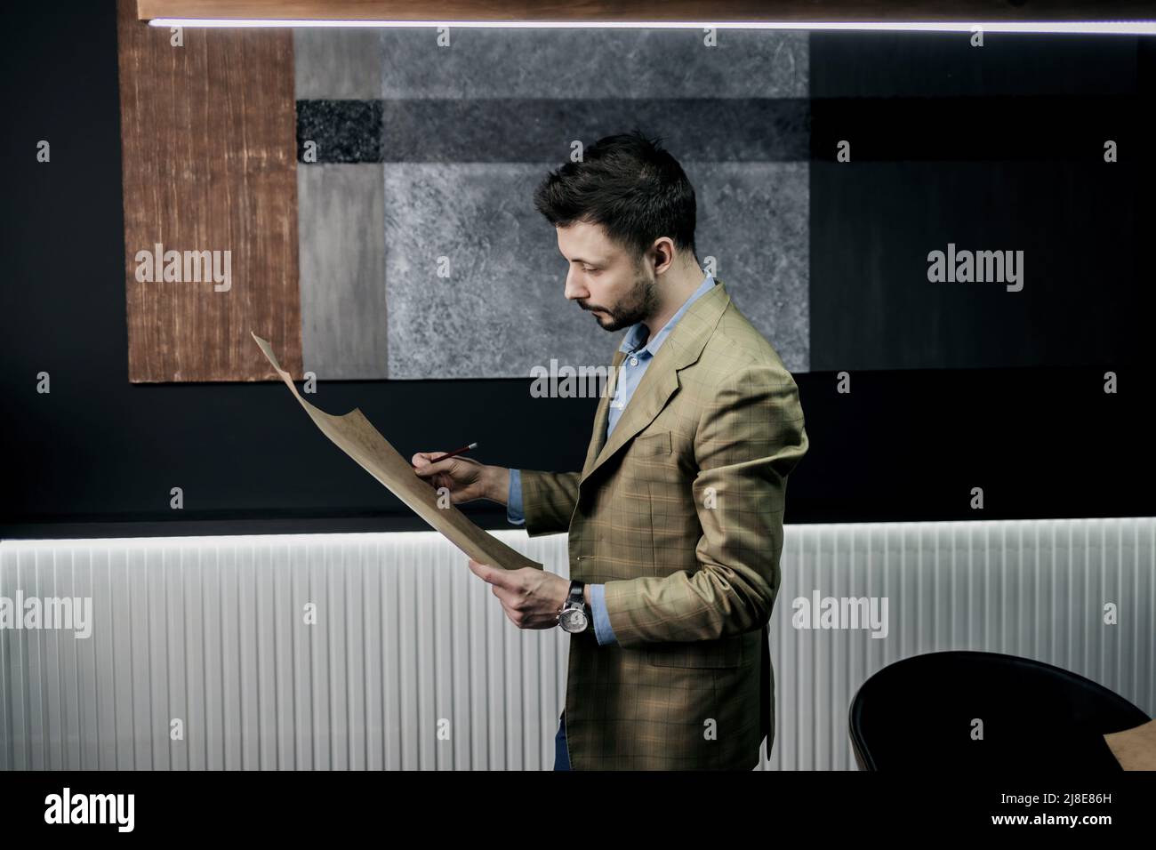 tailor working with sewing pattern in atelier. tailoring. fashion ...