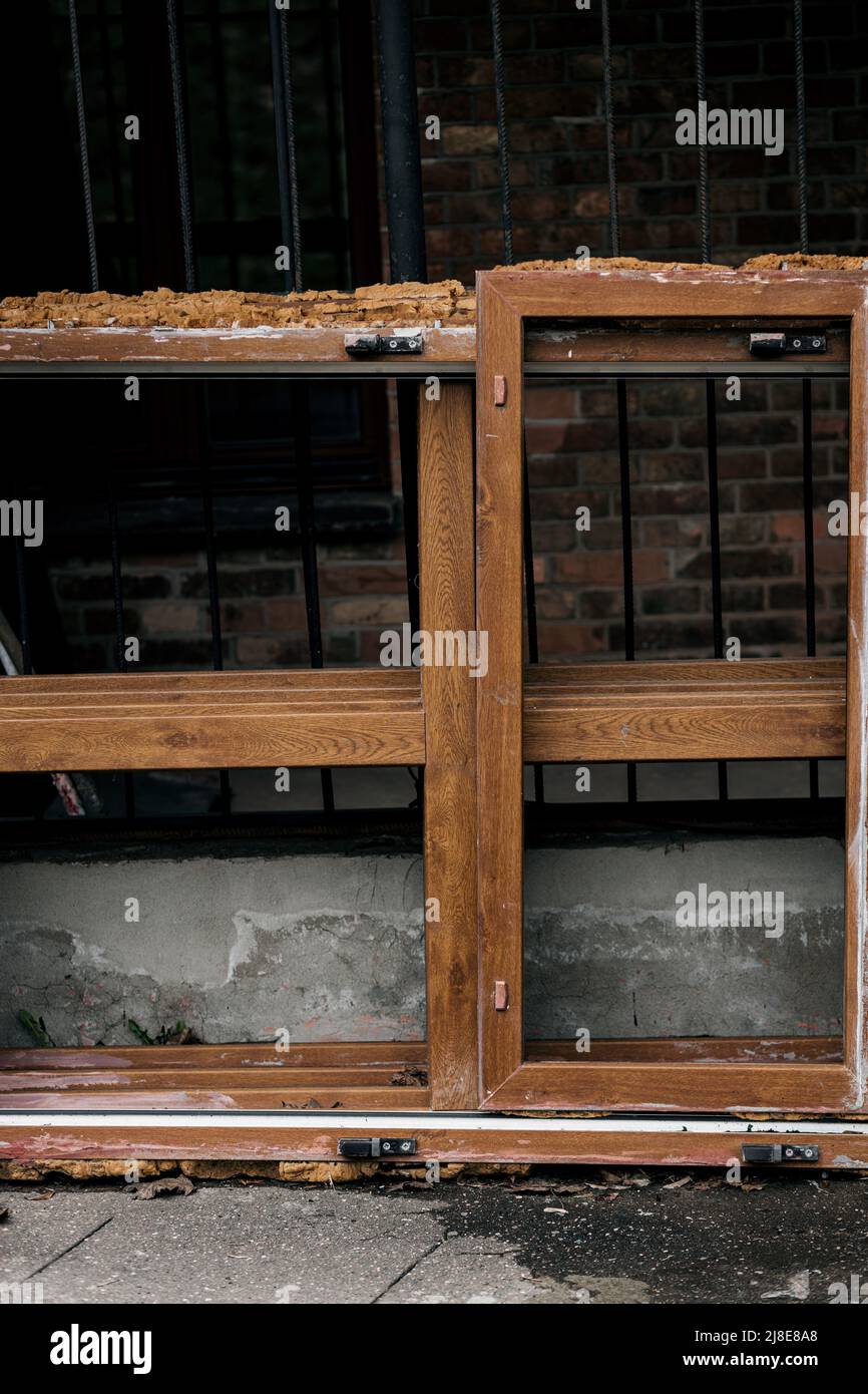 broken old window next to a ruined house abandoned after a disaster ...