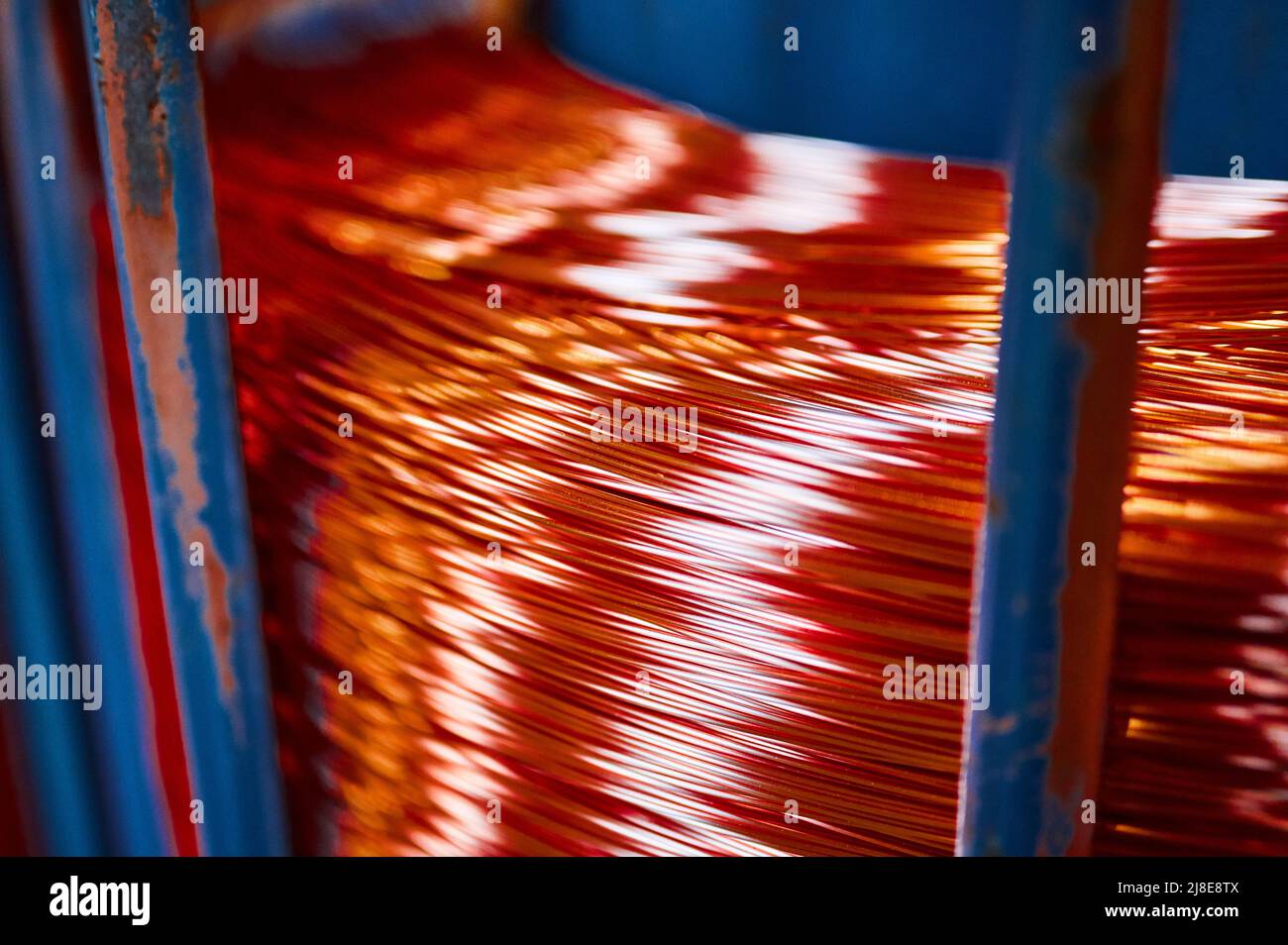 Large bobbin of orange copper wire in light warehouse Stock Photo - Alamy