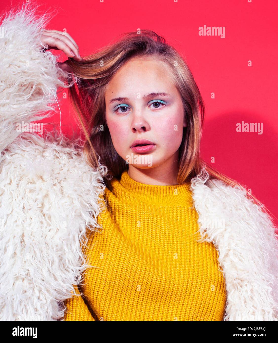 young pretty emitonal posing teenage girl on bright red background ...