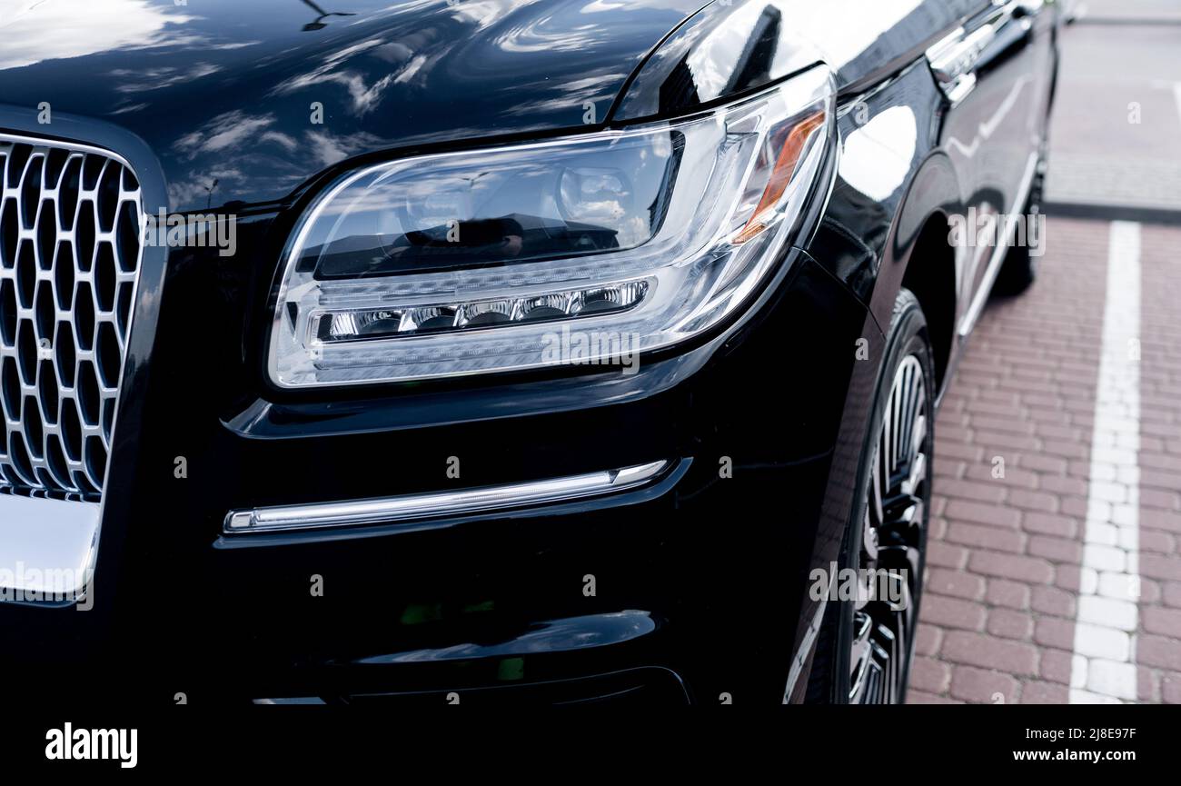 headlight of modern prestigious black car. front view. detail ...