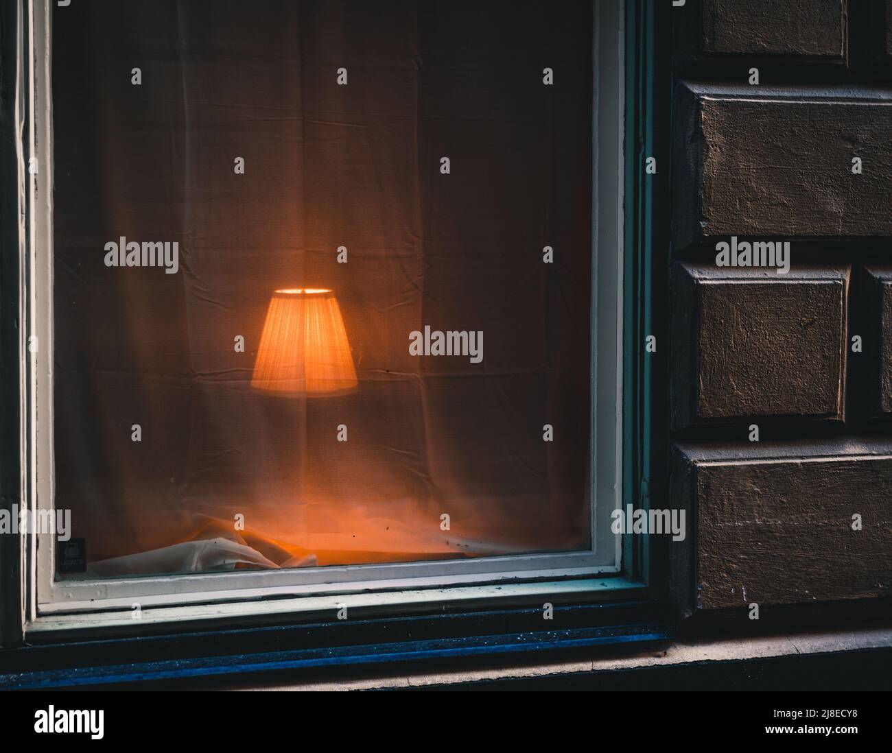 Window of the old house. Window with light of the old house. Cozy light ...