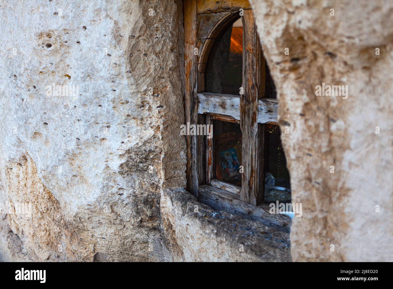 Ancient monastery window , exterior view . Old wooden window and stone ...