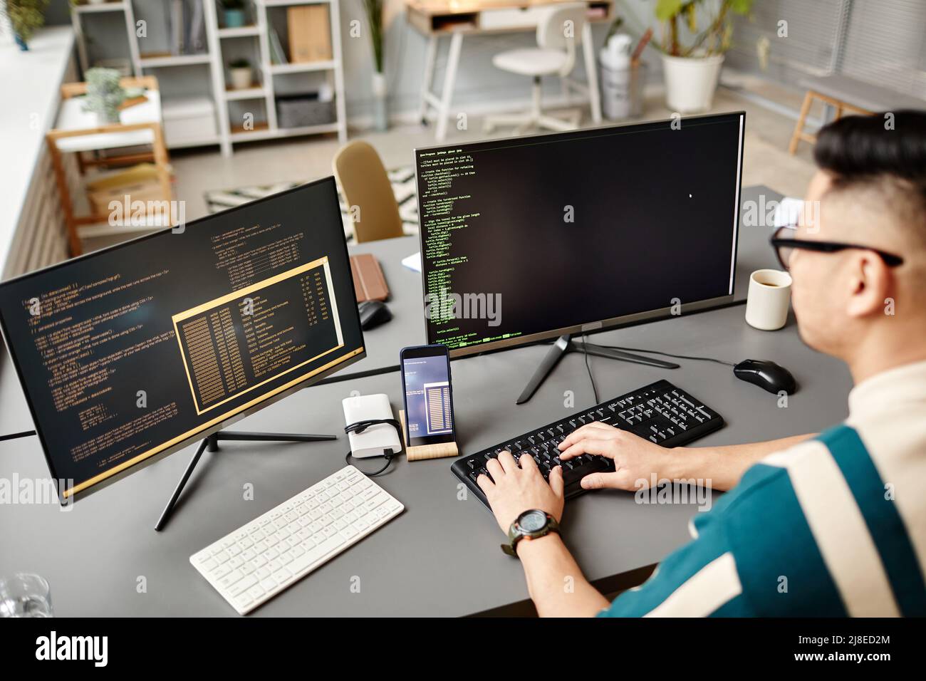 High Angle Portrait Of It Developer Typing On Keyboard With Programming Code On Computer Screen