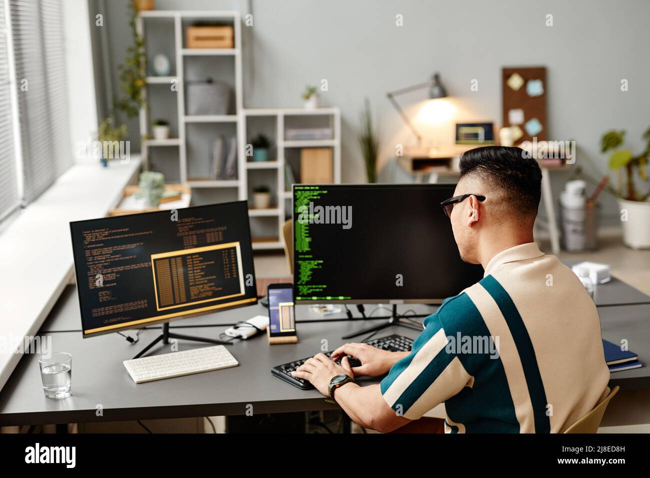 Back view asian male programmer hi-res stock photography and images - Alamy