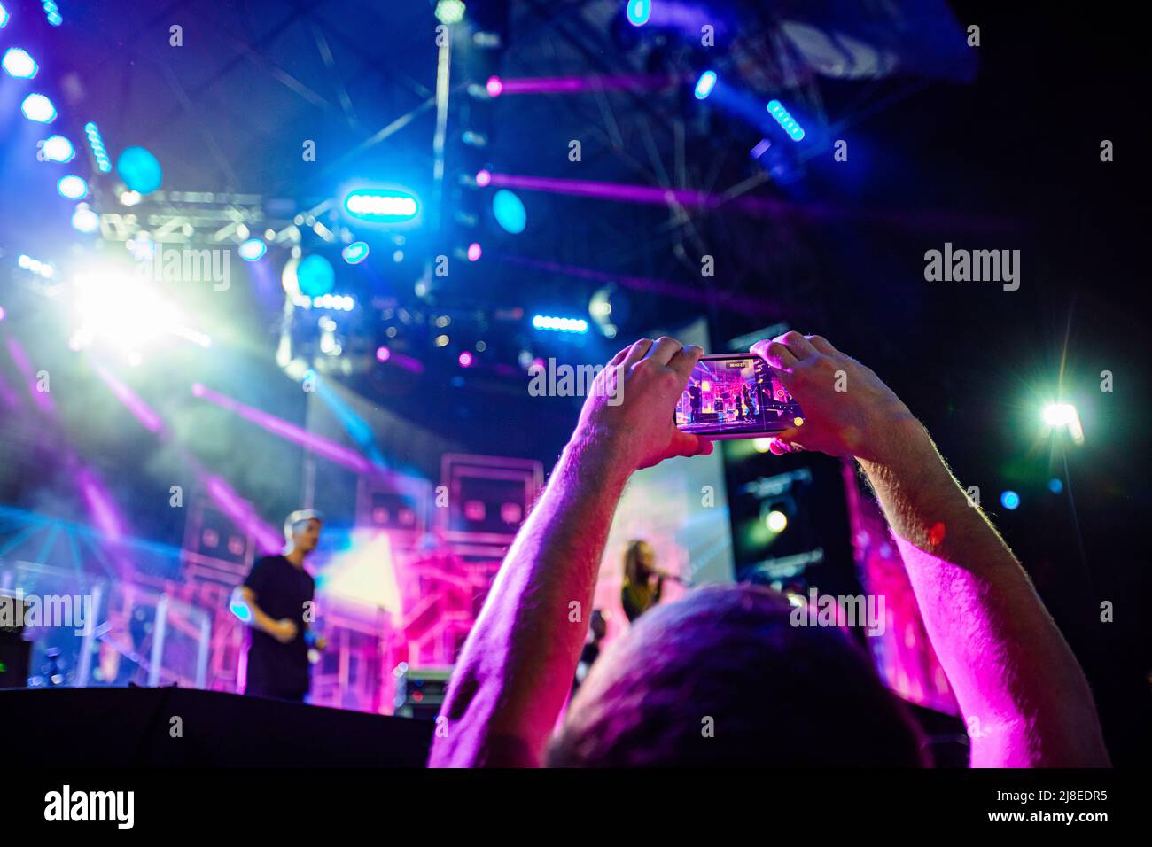 Hands with phones on concert, atmosphere on concert, stage lights Stock ...