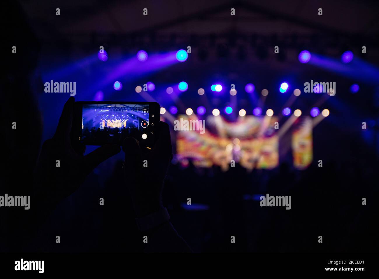 Hands with phones on concert, atmosphere on concert, stage lights Stock ...