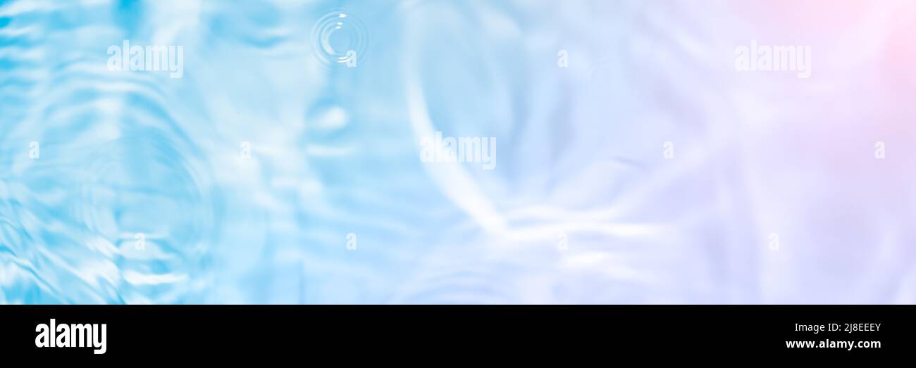 Serum or water texture close up. Light blue and pink gradient liquid ...