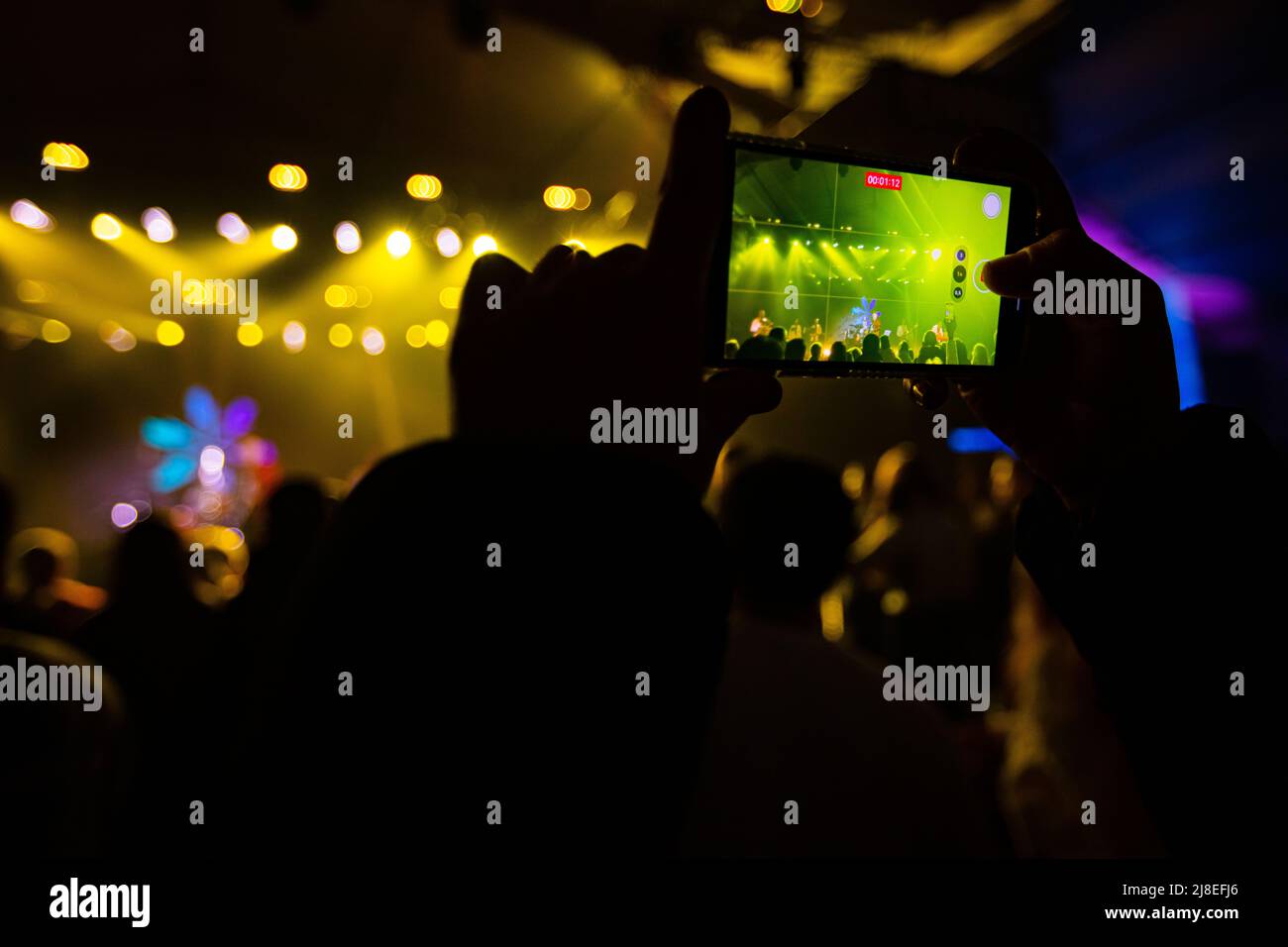 Hands with phones on concert, atmosphere on concert, stage lights Stock ...