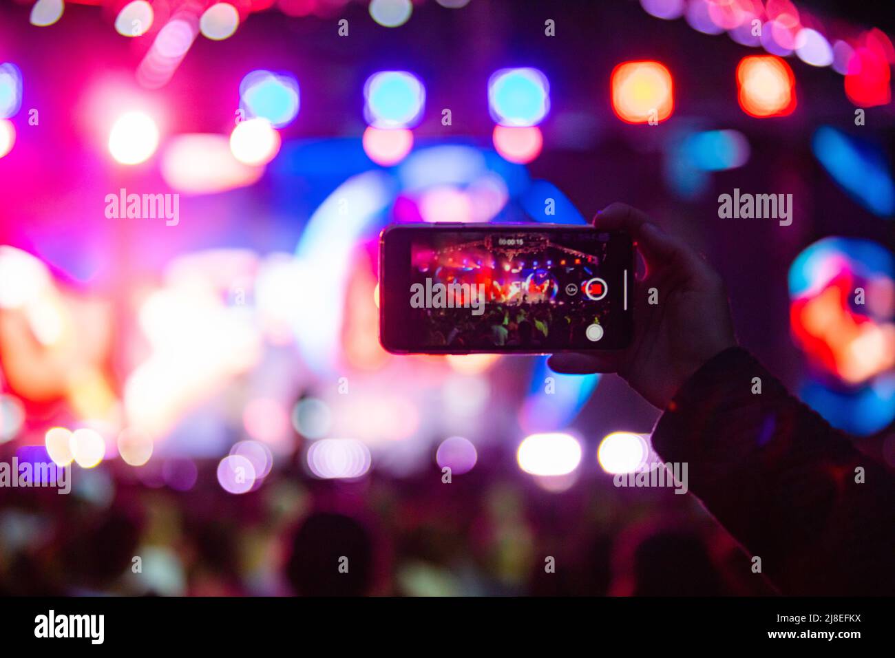 Hands with phones on concert, atmosphere on concert, stage lights Stock ...