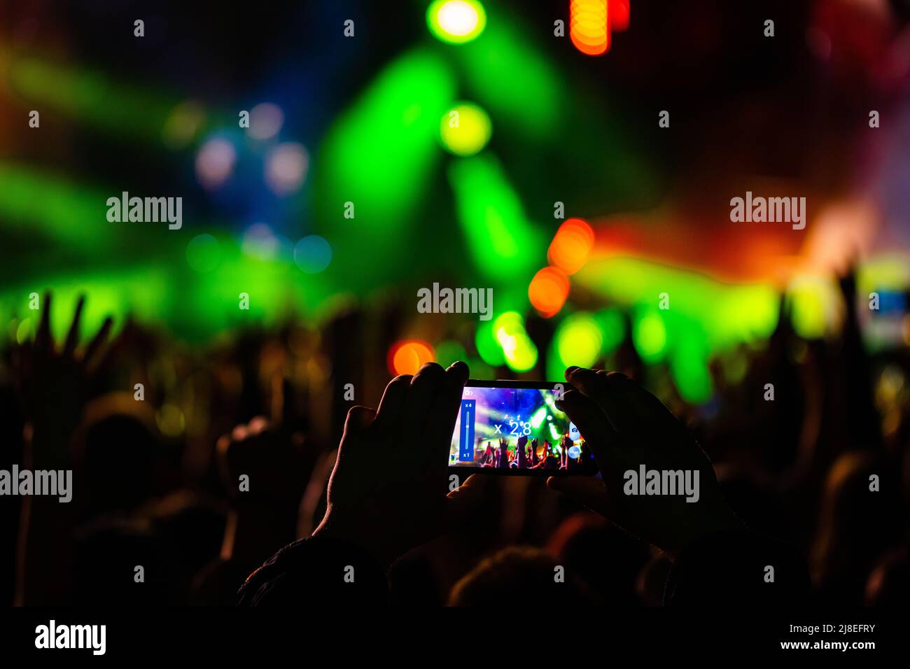 Hands with phones on concert, atmosphere on concert, stage lights Stock ...