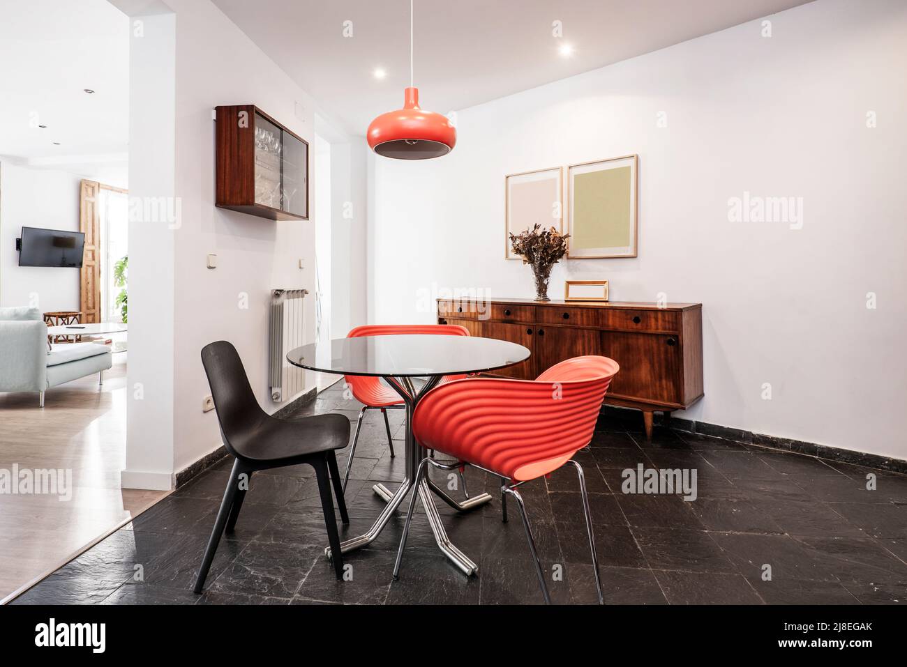 Office area of a kitchen with a large wooden cabinet, a circular glass ...