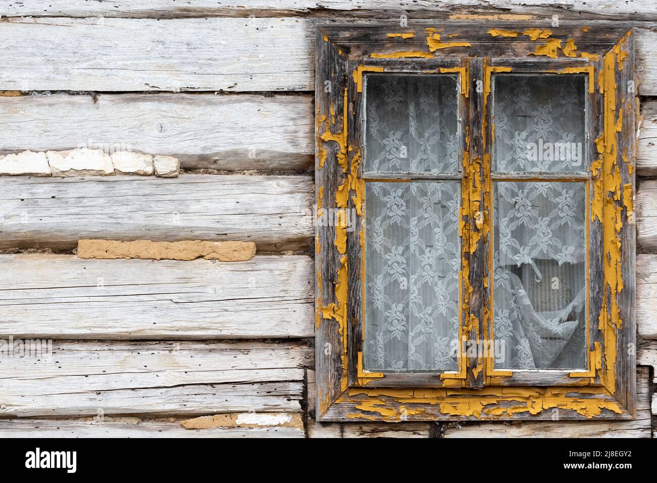Window in an old wooden house. A decaying rural old wooden house. Wall ...