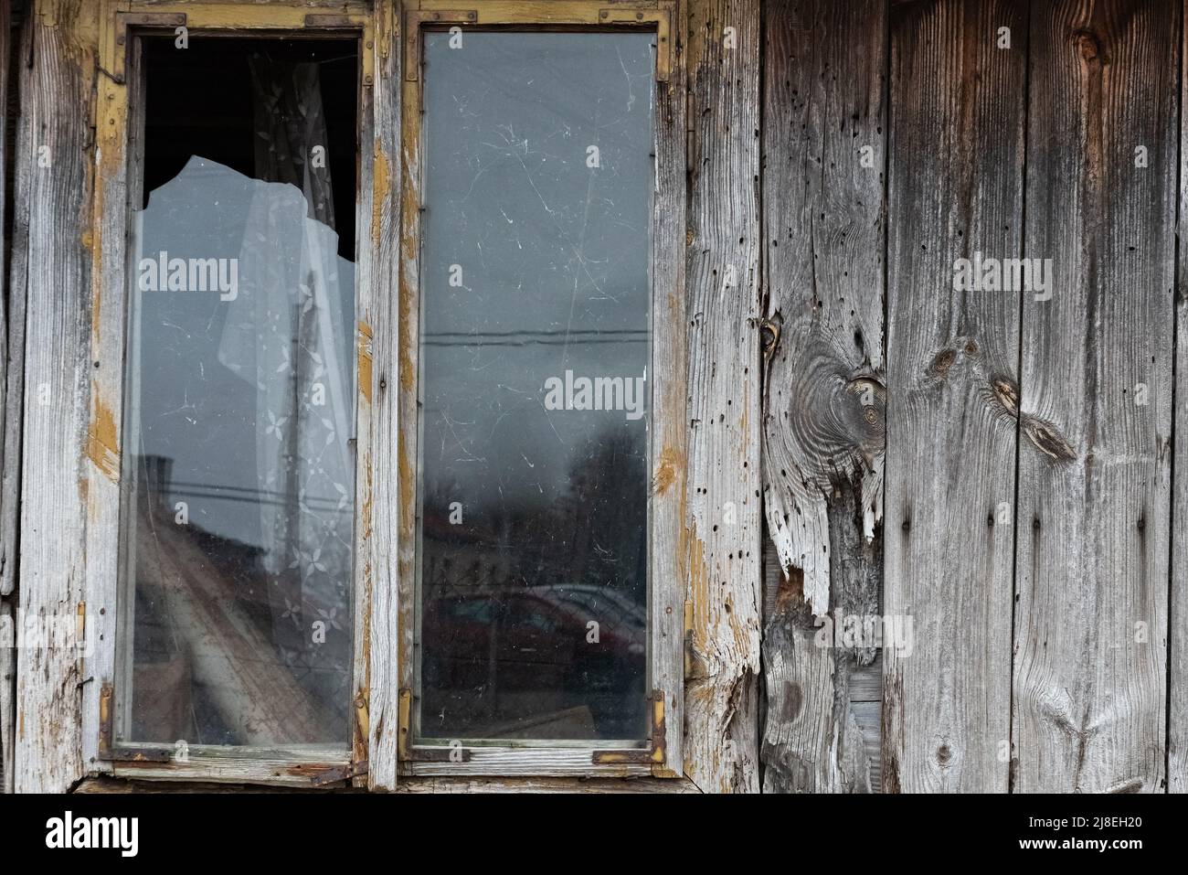 Window in an old wooden house. A decaying rural old wooden house. Wall ...