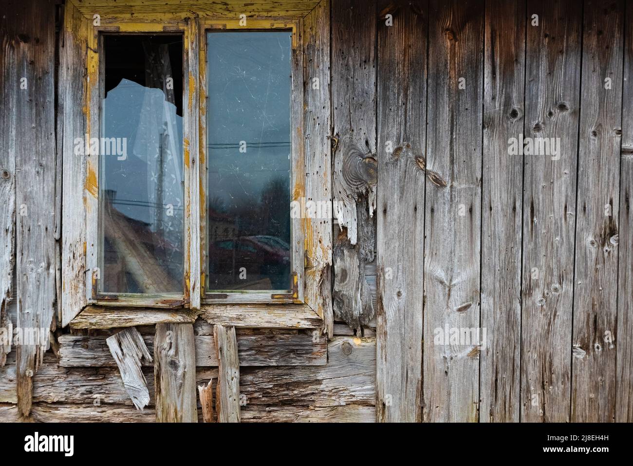 Window in an old wooden house. A decaying rural old wooden house. Wall ...
