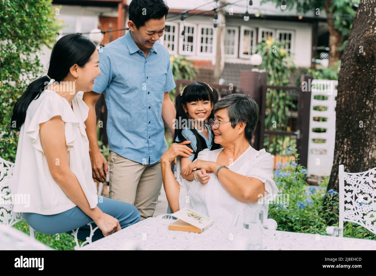 Group of multi-generational Asian family enjoying a good time together ...
