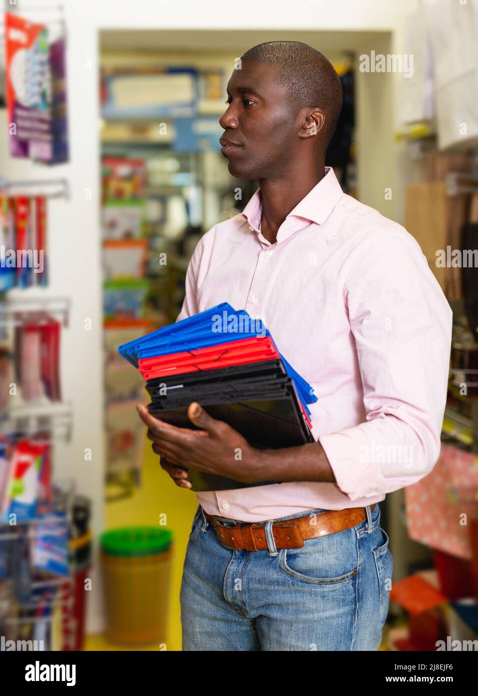 African american male customer looking documents folder Stock Photo - Alamy