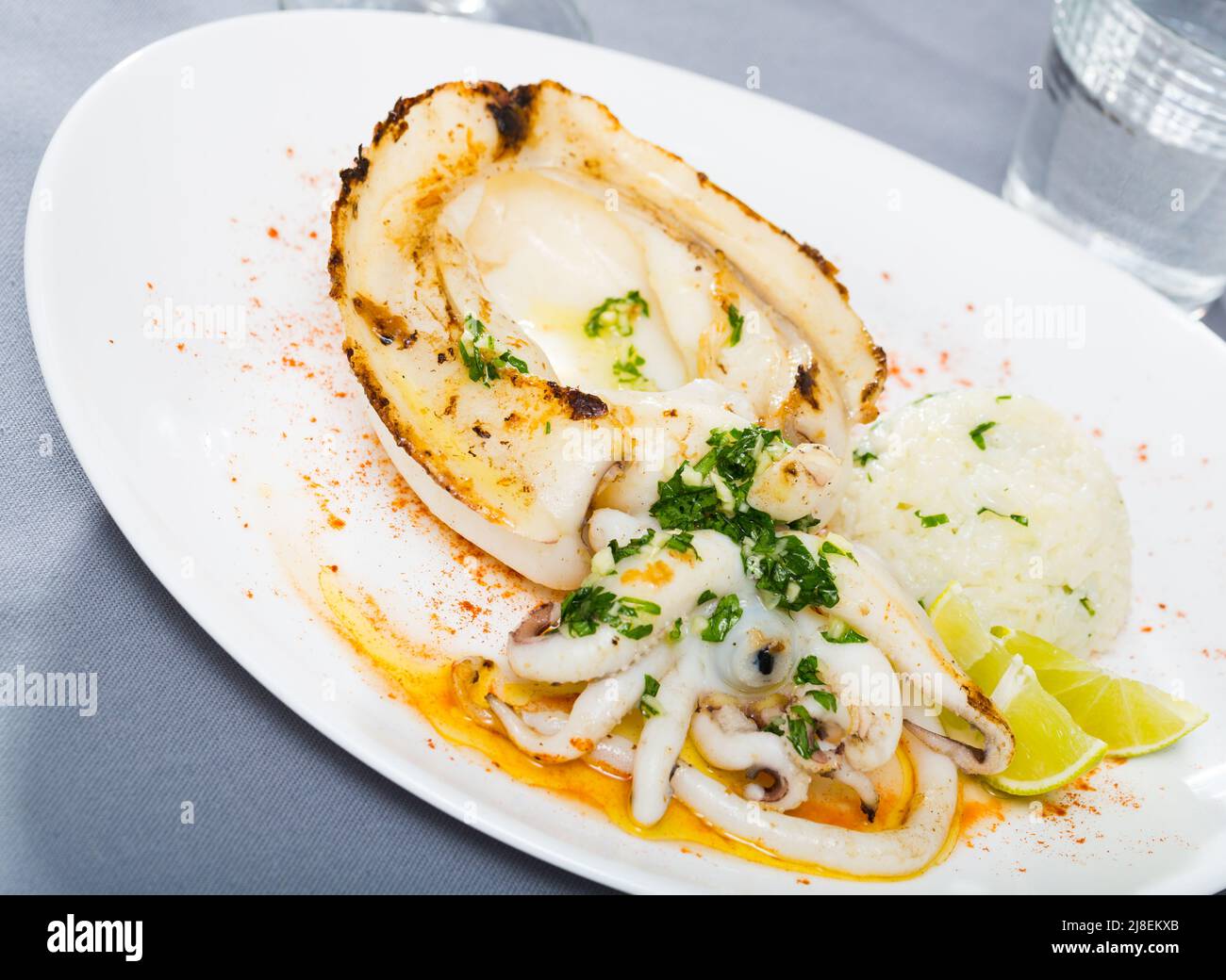 Baked in oven cuttlefish, rice, lemon Stock Photo - Alamy