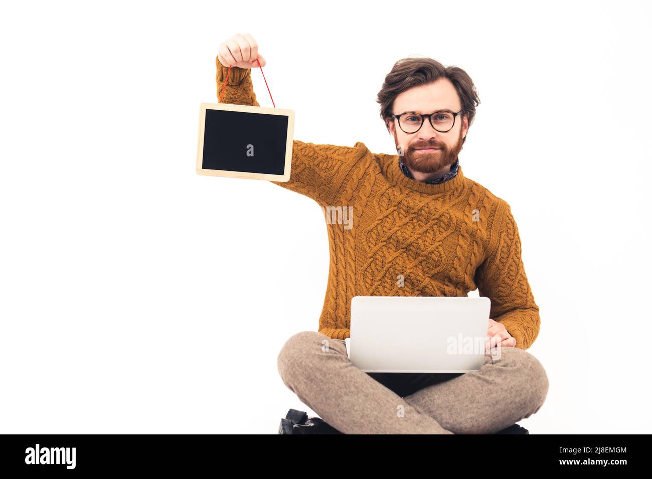 Young man smiling sitting cross legged hi-res stock photography and ...
