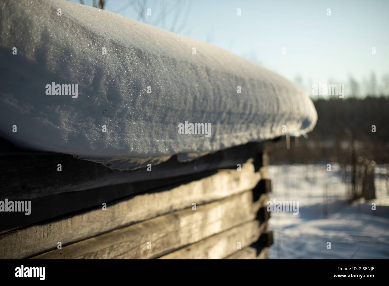 Winter in Russia. Snow on roof of hut. Old house made of wood. Wall of ...