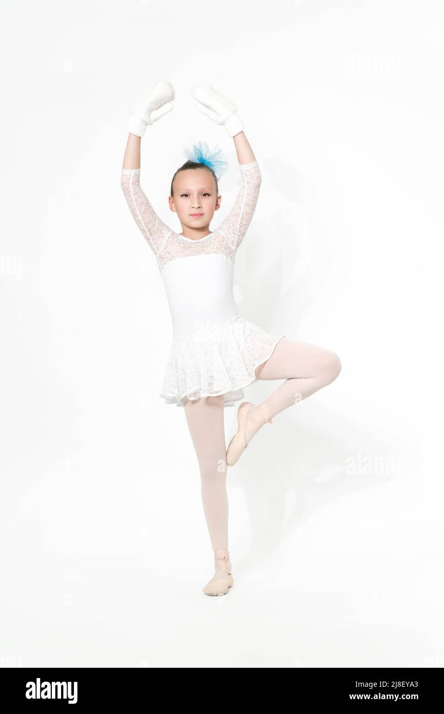 Caucasian girl ballet dancer in white ballet tutu skirt, blue bow in ...