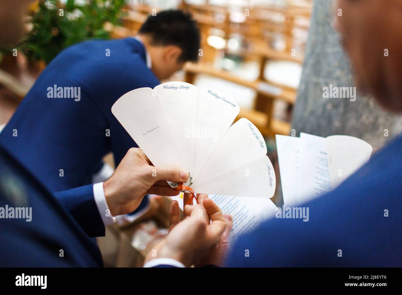 Wedding invitations in the hands of the best man Stock Photo - Alamy