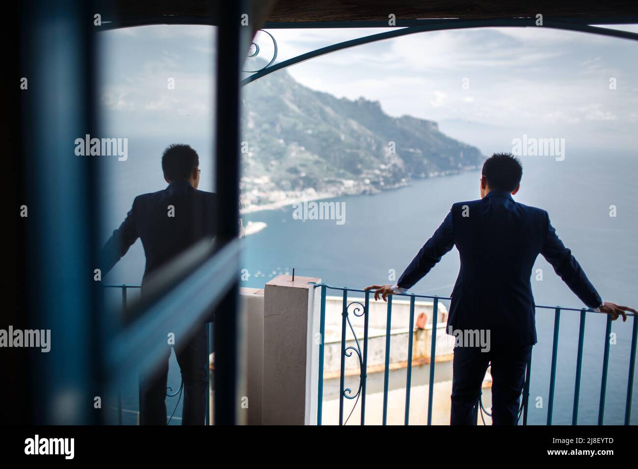 The groom is waiting for the bride on the balcony Stock Photo - Alamy