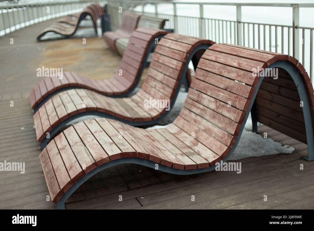 Benches for recreation in park. Comfortable seating. Sun beds on ...