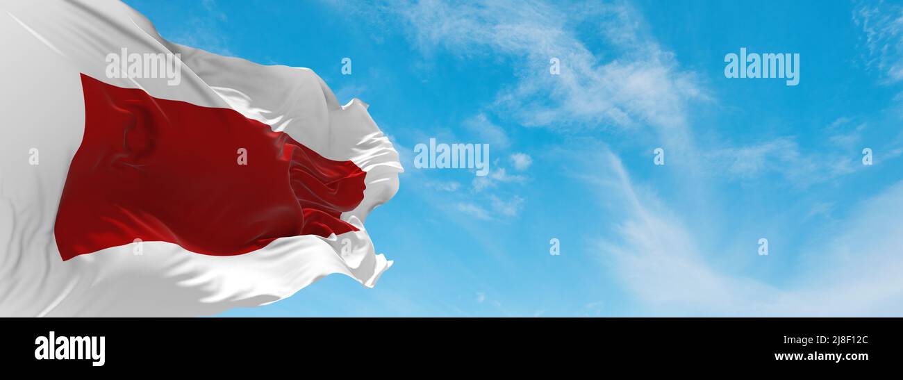 official flag of Sharjah , United Arab Emirates at cloudy sky ...
