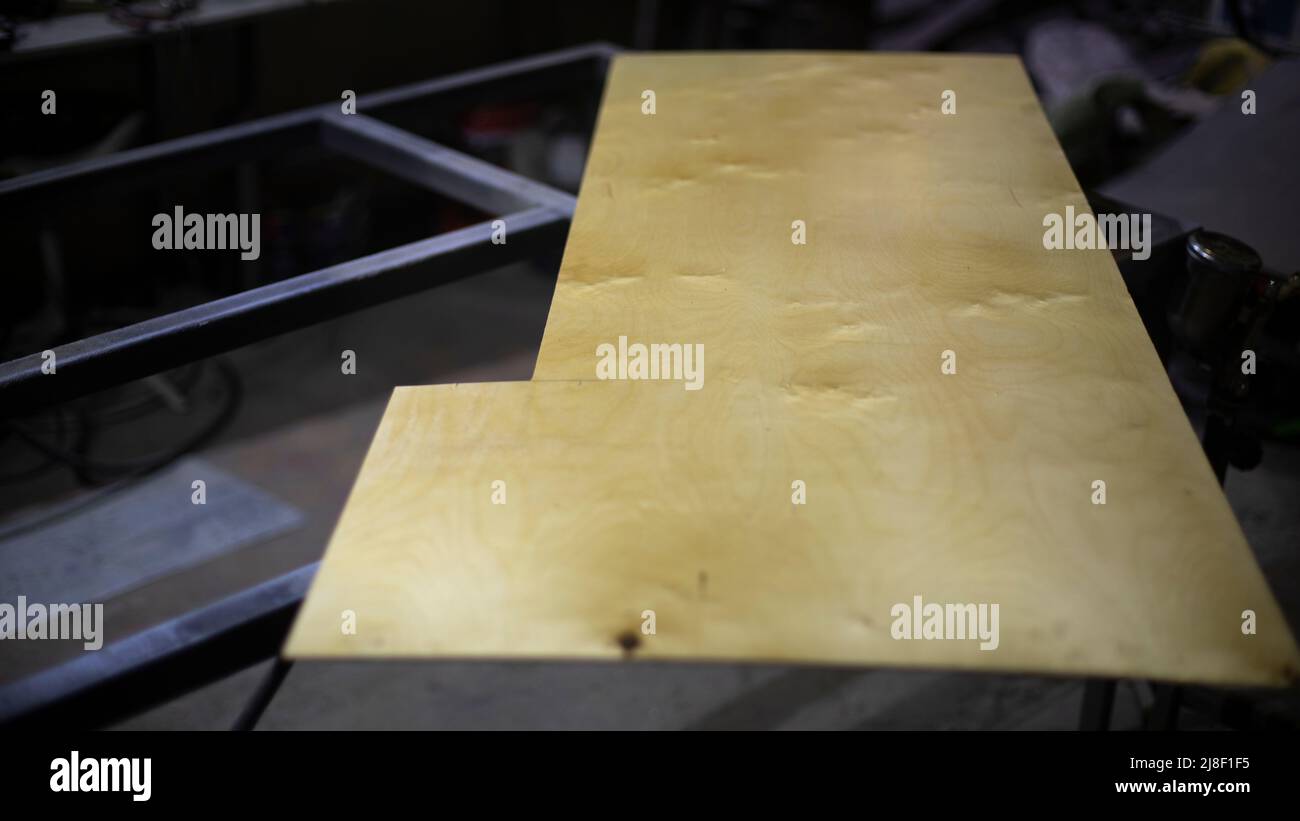 Board is thin. Details of carpentry workshop. Tree is on table. Carved ...