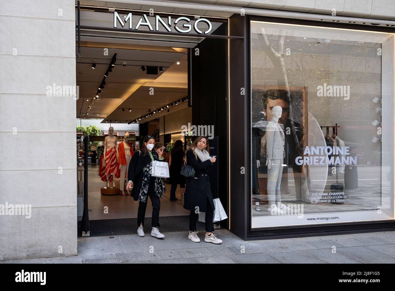 Shoppers leave the Spanish multinational clothing brand Mango store in ...